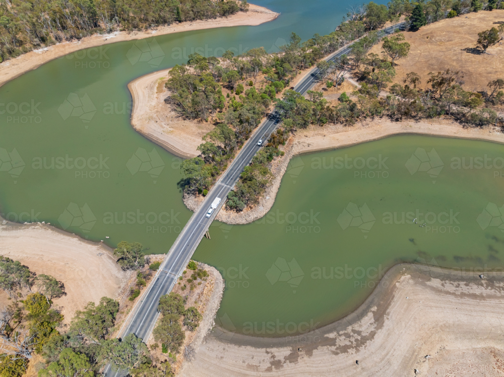 Image of Aerial view of a bridge crossing an inland reservoir with ...