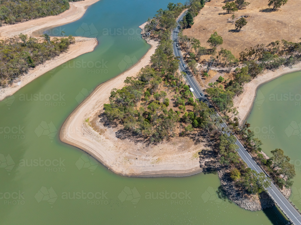 Image of Aerial view of a bridge crossing an inland reservoir with ...