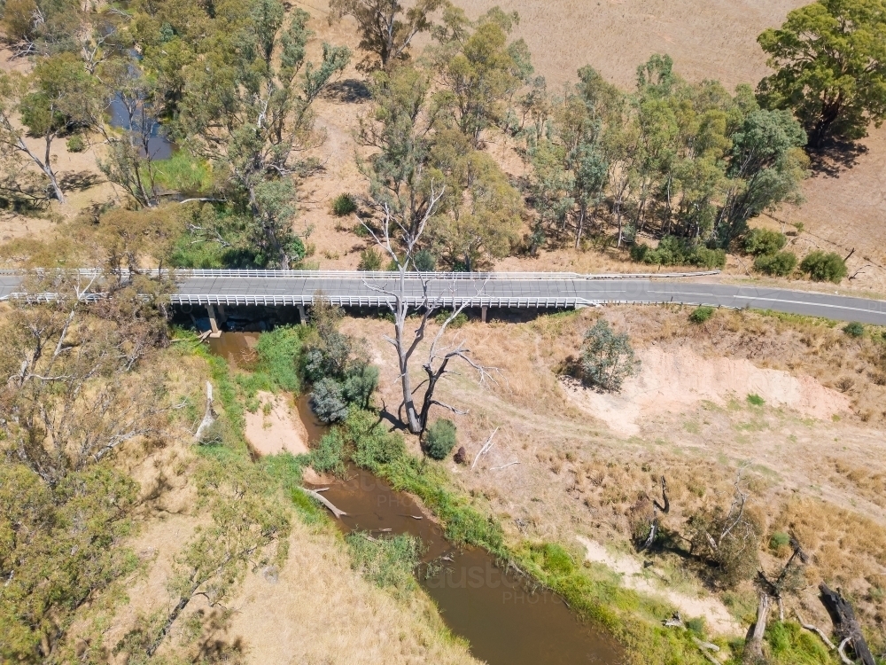 Image of Aerial view of a bridge on a country road crossing over a ...