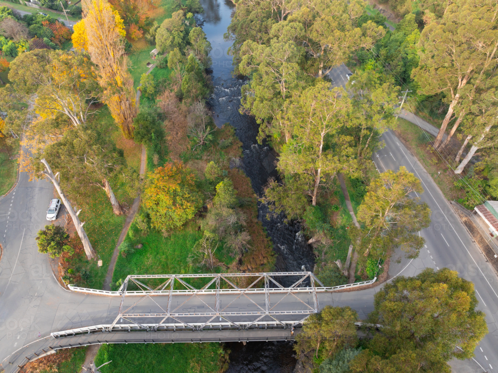 Image of Aerial view of a bridge over a narrow river joining roads on ...