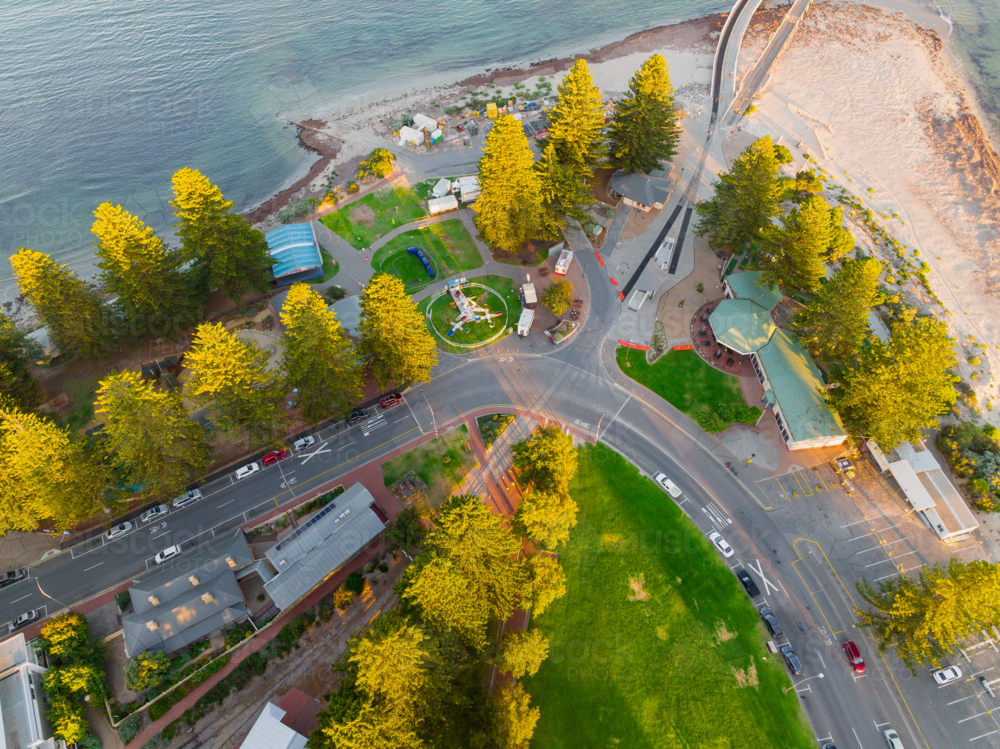 Image of Aerial view of a busy coastal esplanade lined with trees and ...