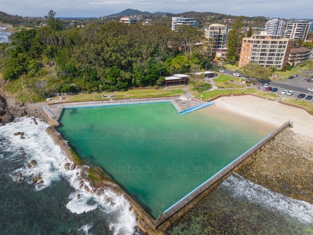 Image of Aerial view of a calm ocean bath next a beach and waterfront ...