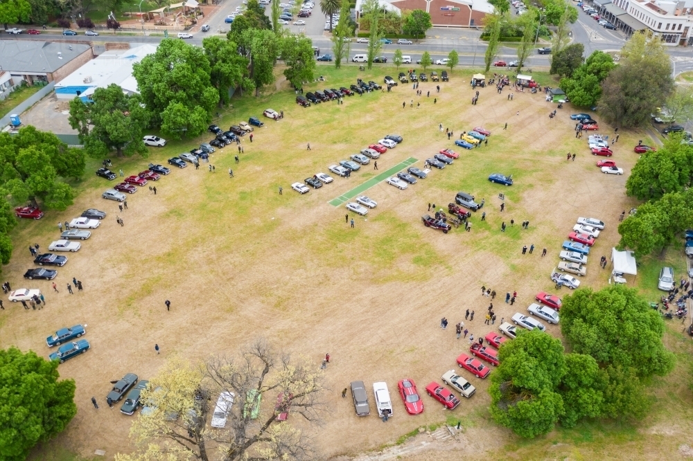 Image of Aerial view of a car rally parked around a cricket oval ...