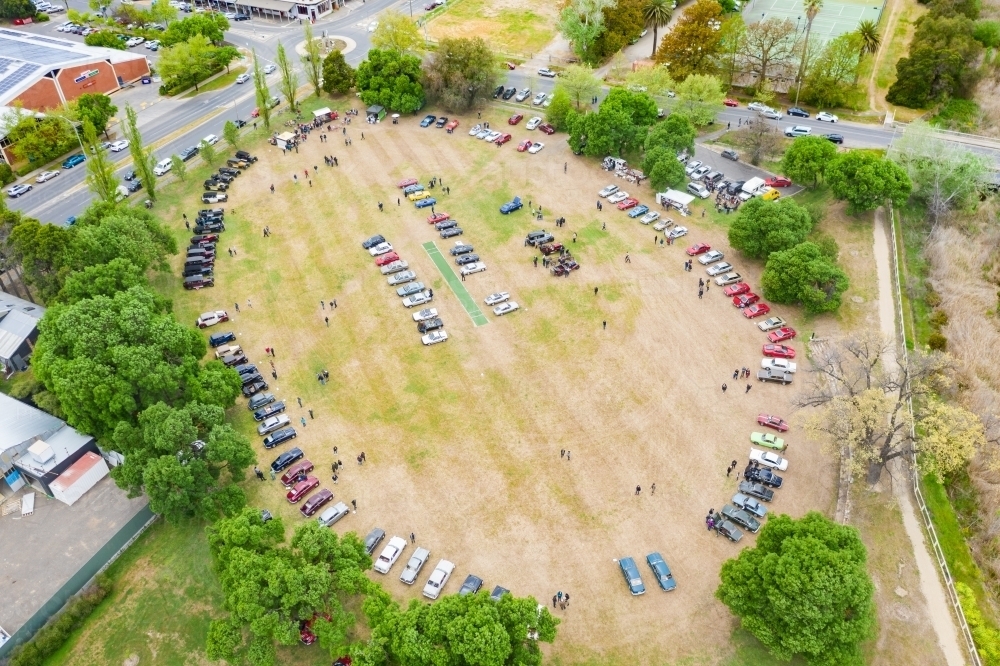 Image of Aerial view of a car rally parked around a cricket oval ...
