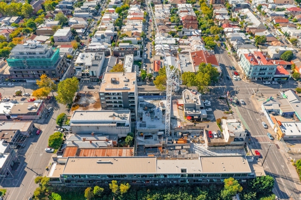 Image of Aerial view of a city construction sight with a large crane ...