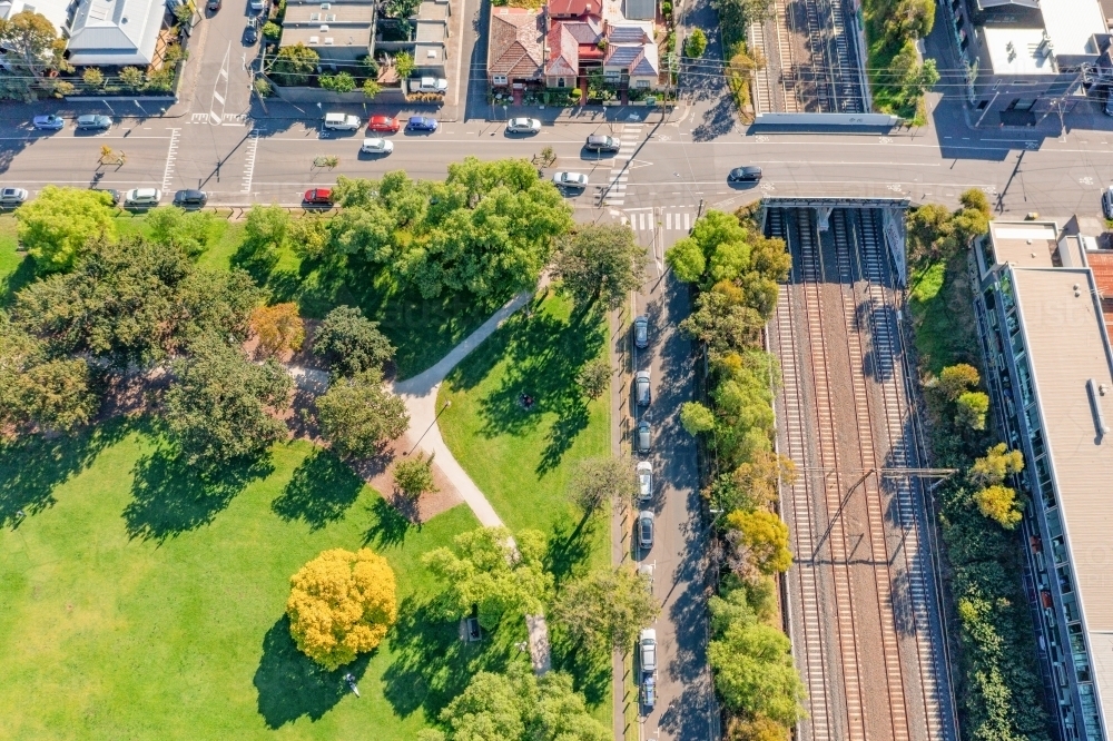 Image of Aerial view of a city park with walking tracks alongside ...