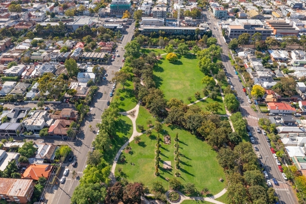 Image of Aerial view of a city park with walking tracks and tree lines ...
