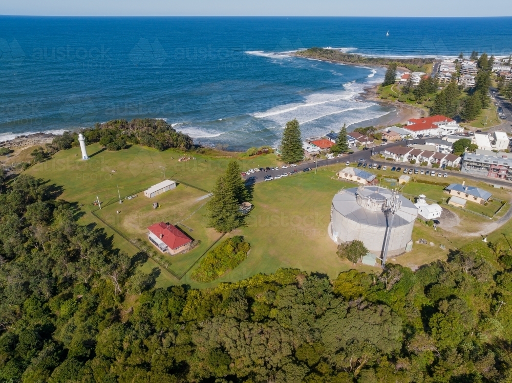 Image of Aerial view of a coastal headland with a lighthouse and water ...