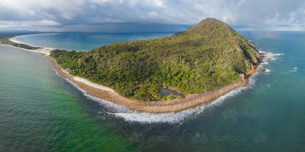 Image of Aerial view of a coastal headland with dramatic clouds above ...
