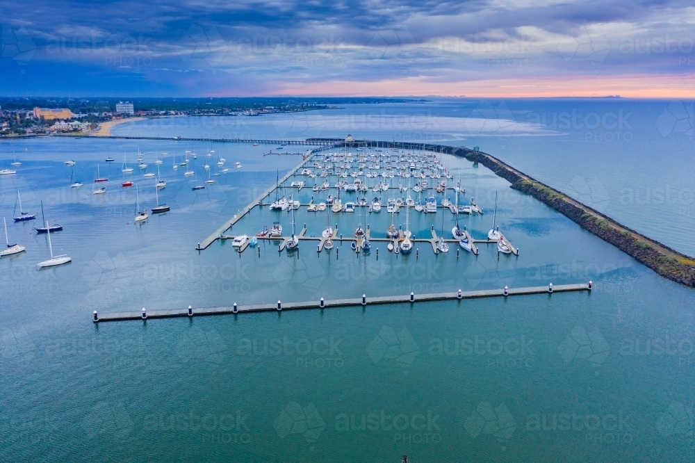 Image of Aerial view of a coastal marina at sunset - Austockphoto
