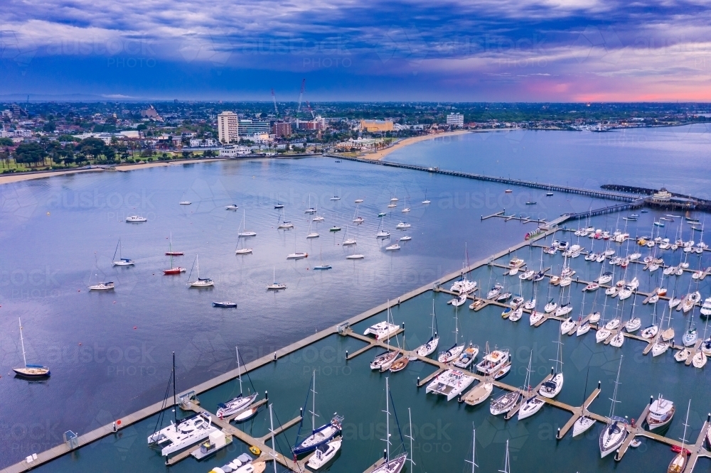 Image of Aerial view of a coastal marina at sunset - Austockphoto