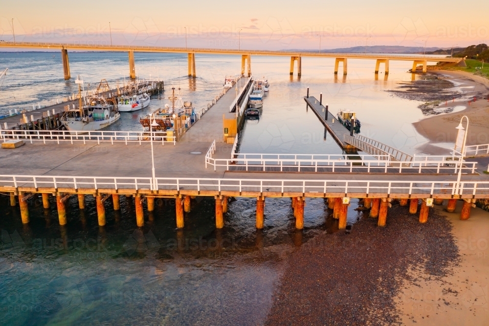 Image of Aerial view of a coastal marina with fishing boats docked at ...