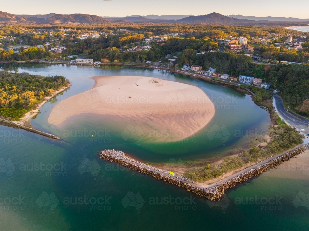 Image of Aerial view of a coastal resort around a man made breakwater ...