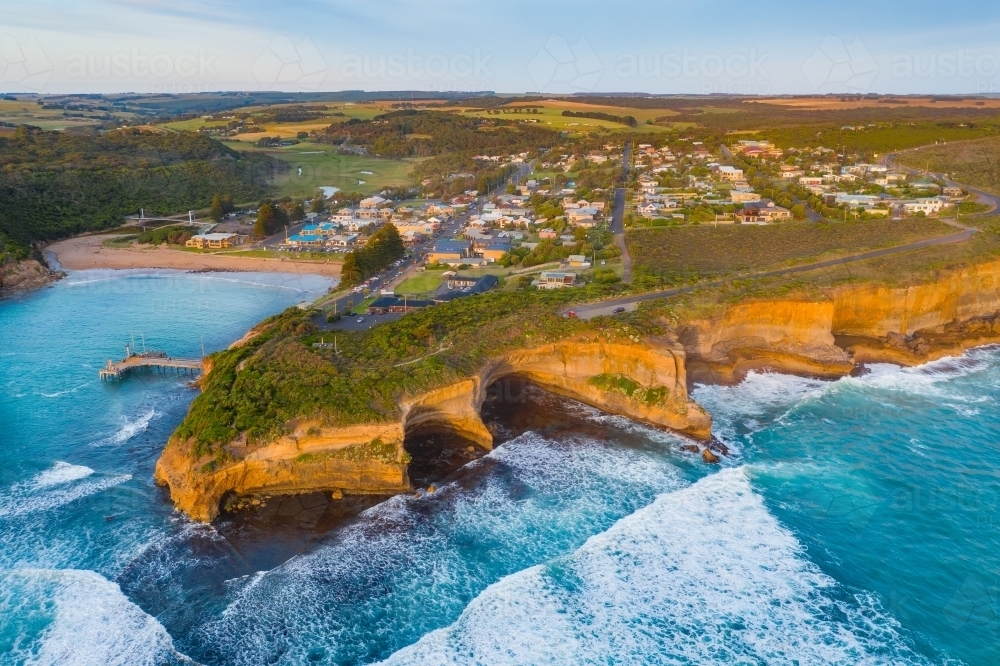 Image of Aerial view of a coastal town on sea cliffs above a rugged ...