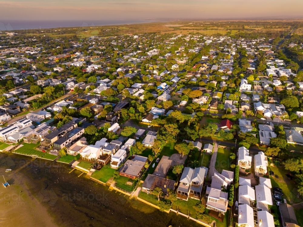 Image of Aerial view of a coastal township in early morning light ...