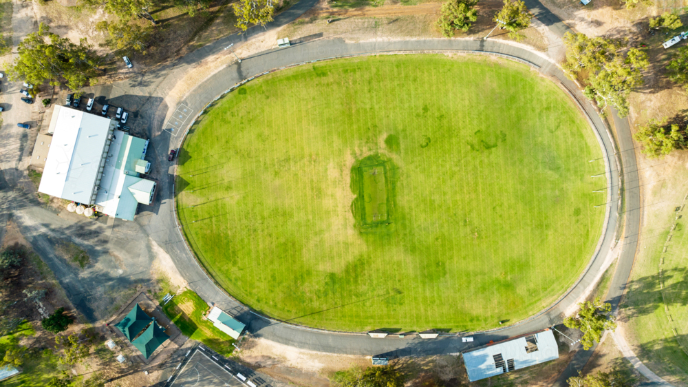 Image of Aerial view of a country cricket ground with central pitch and ...