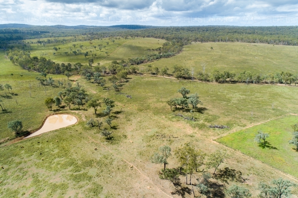 Image of Aerial view of a dam and farm paddock. - Austockphoto