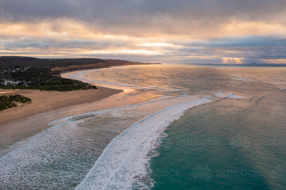 Image of Aerial view of a dramatic sunrise over a beach around a ...