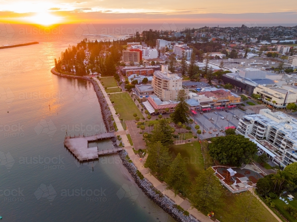Image of Aerial view of a dramatic sunrise over waterfront buildings ...