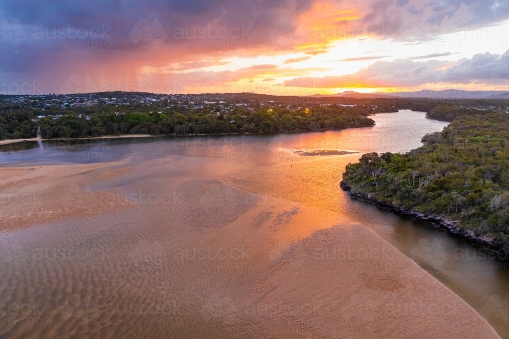 Image of Aerial view of a dramatic sunset sky over an inland river ...