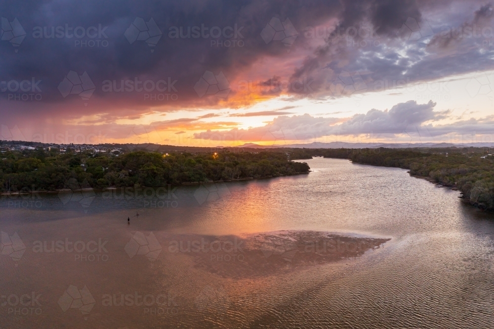 Image of Aerial view of a dramatic sunset sky over an inland river ...
