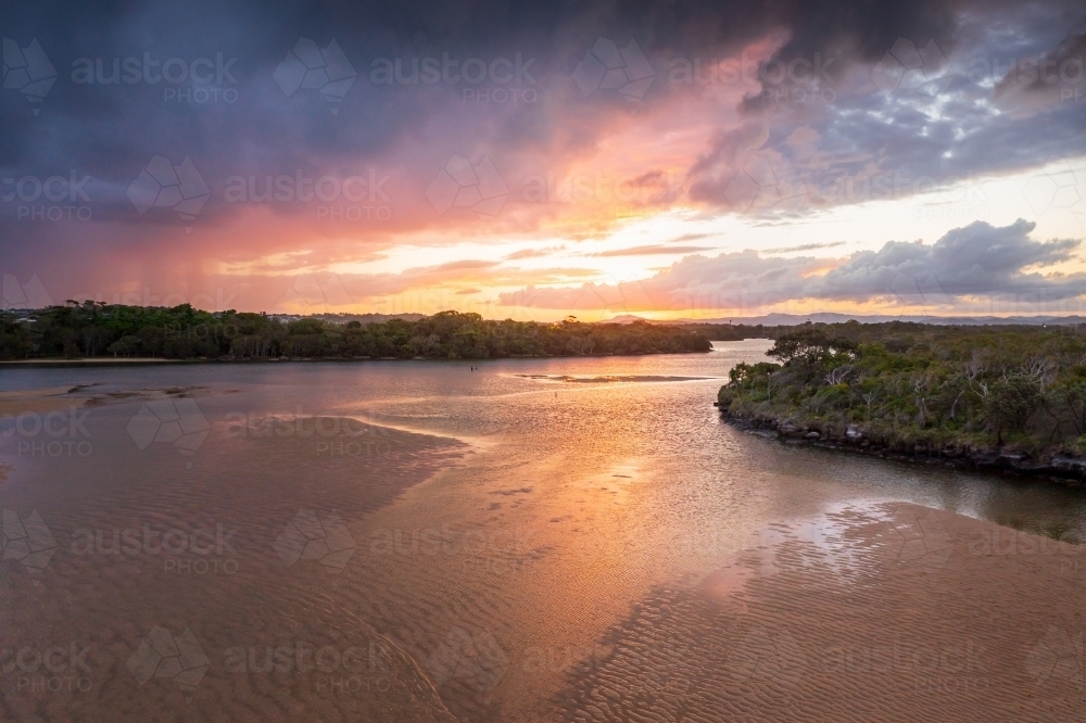 Image of Aerial view of a dramatic sunset sky over an inland river ...