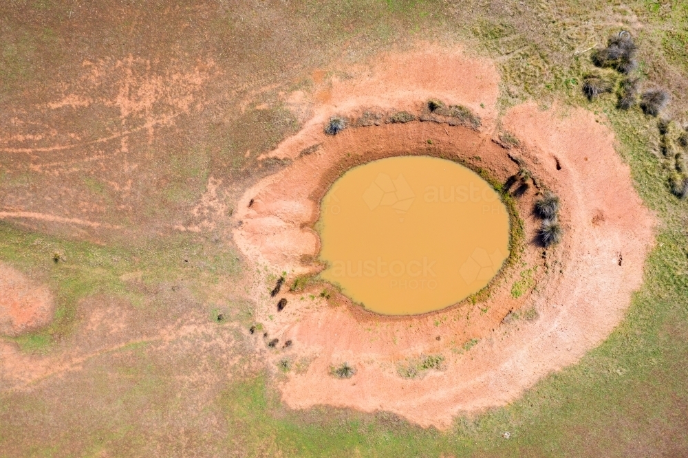 Image of Aerial view of a farm dam with dried edges - Austockphoto