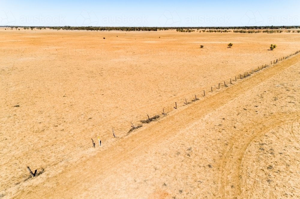 Image of Aerial view of a fence and dusty paddock in drought affected ...