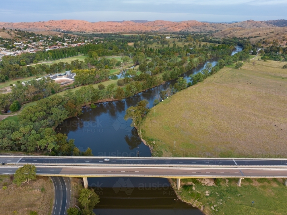 Image of Aerial view of a freeway bridge over a wide river with a rural ...