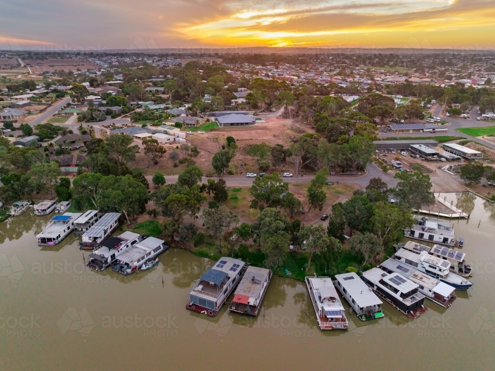 Image of Aerial view of a house boat marina on a river with a sunset ...