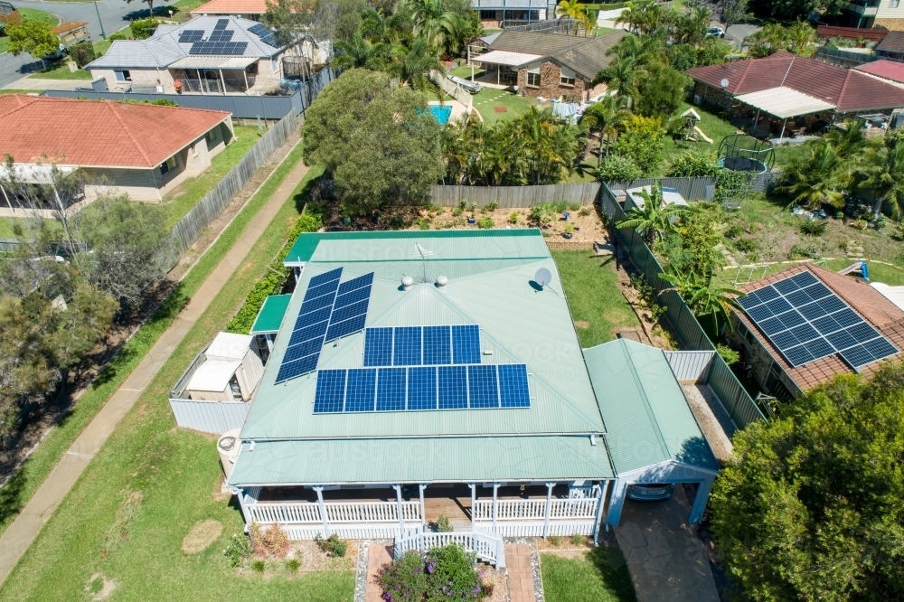 Image of Aerial view of a house with solar panels. - Austockphoto