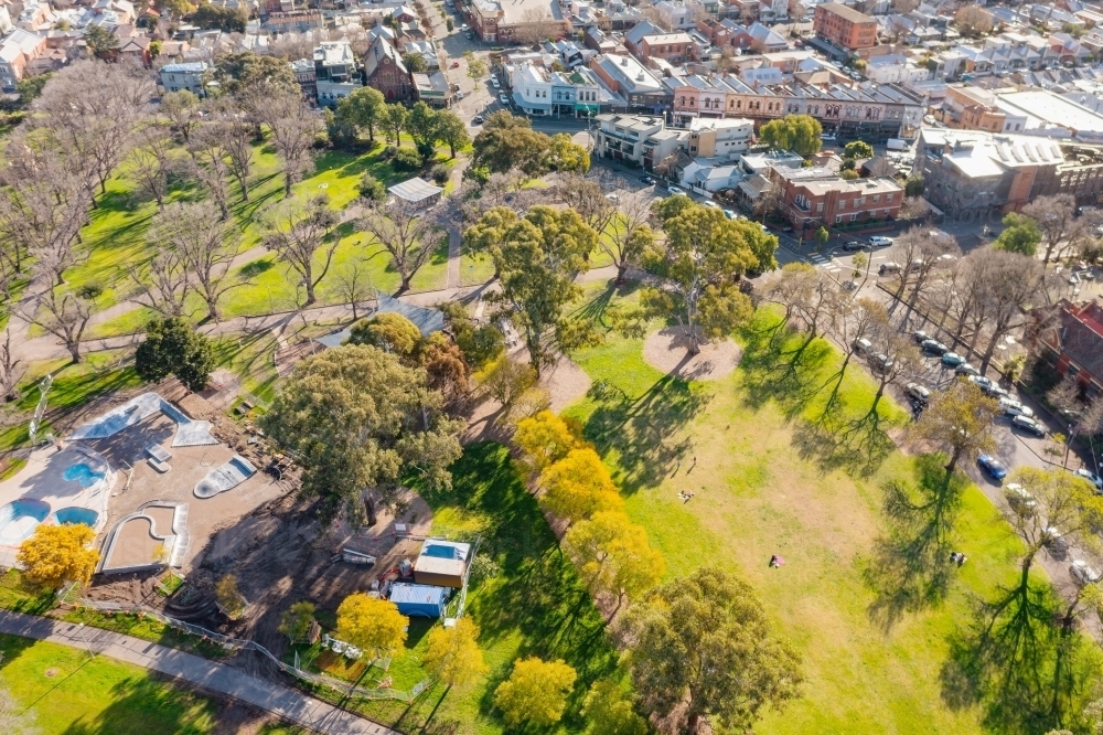 Image of Aerial view of a housing area around a suburban park under ...