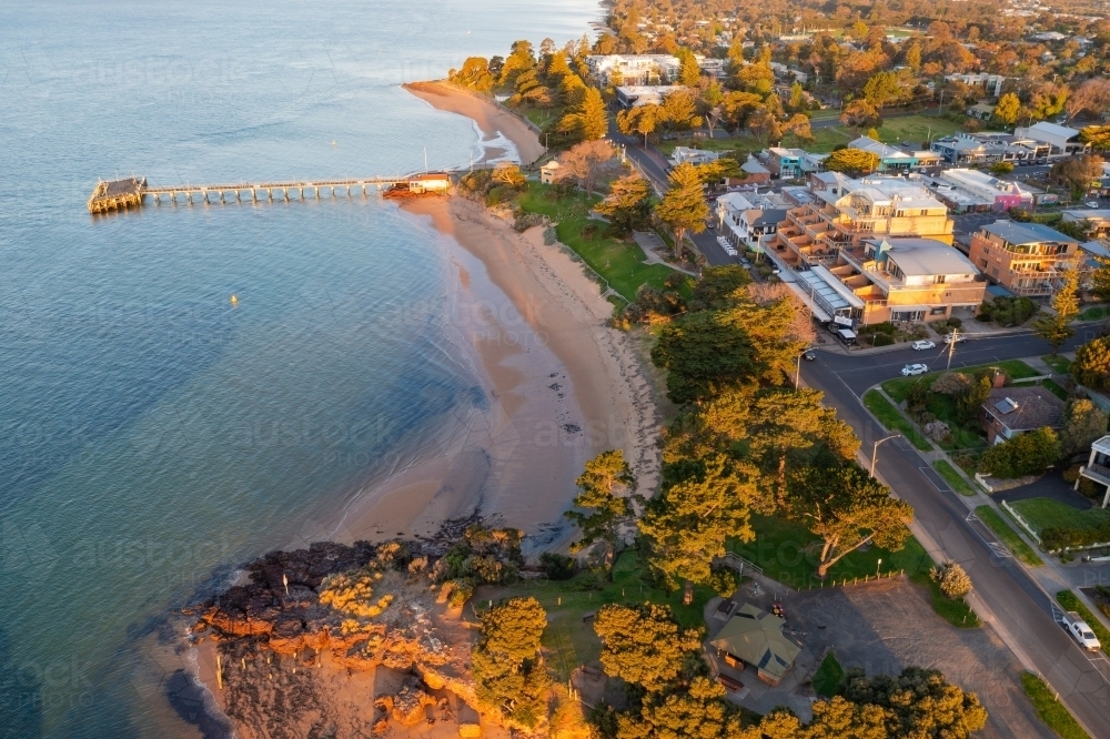 Image of Aerial view of a jetty jutting out from a beach side reserve ...