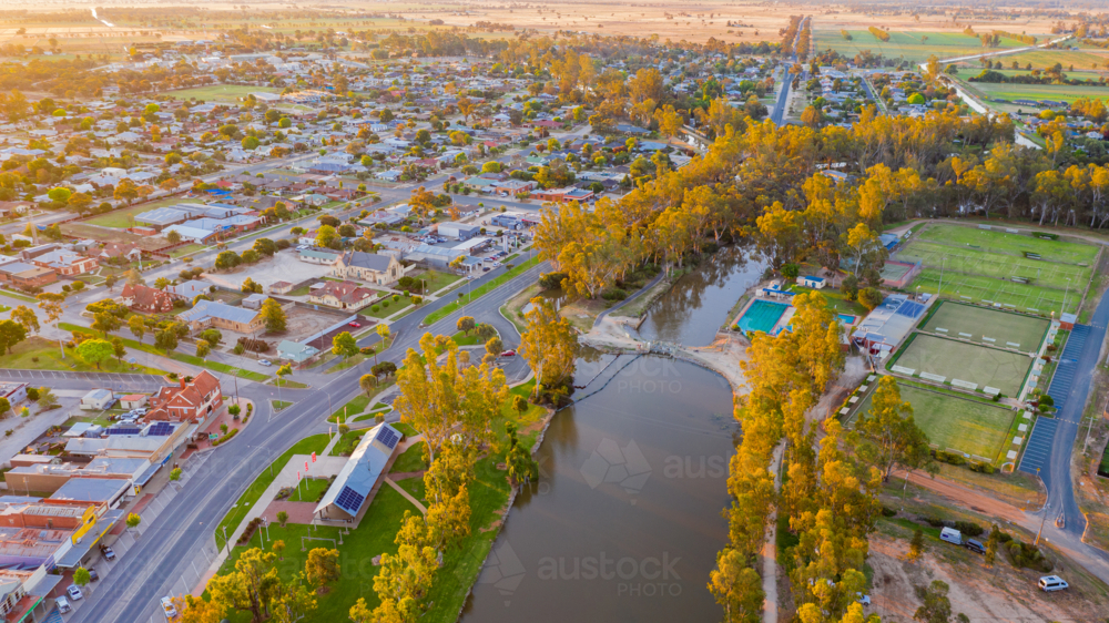 Image of Aerial view of a lake and parkland around a rural town centre ...