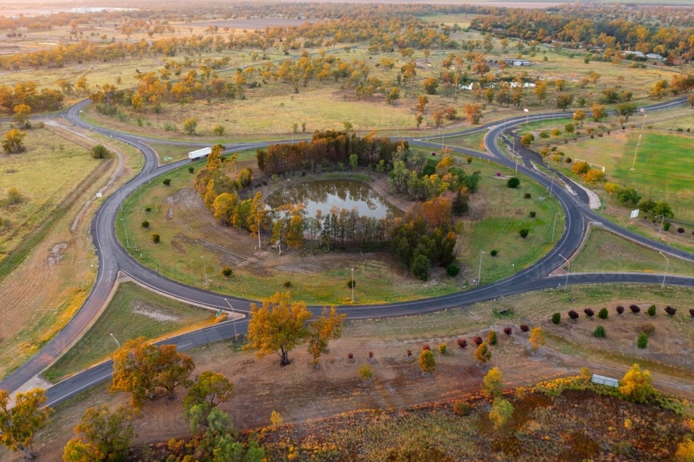 Image of Aerial view of a lake in the middle of a large roundabout in a ...