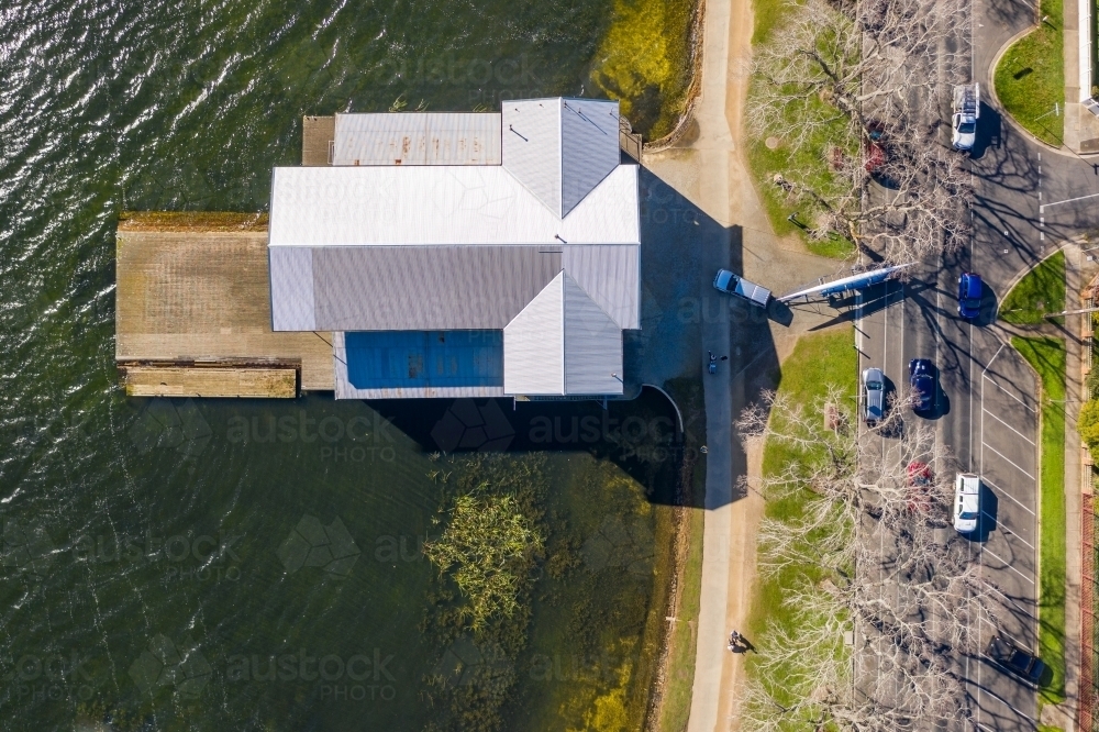 Image of Aerial view of a large boat shed on the shores of a lake ...