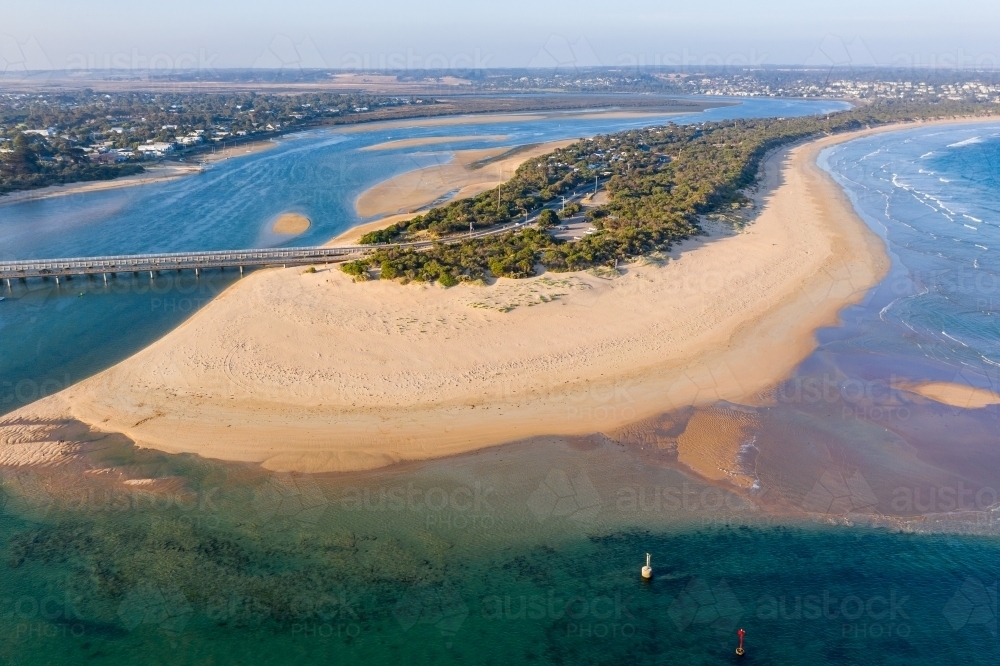 Image of Aerial view of a large sand spit and bridge crossing a tidal ...