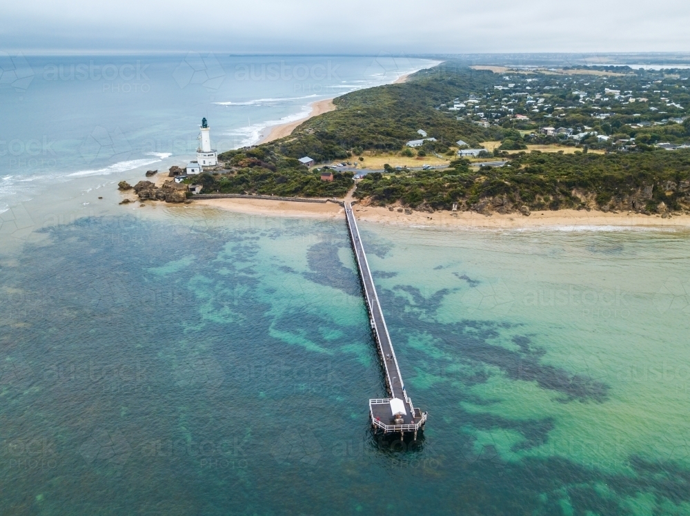 Image of Aerial view of a lighthouse and jetty jutting out into the ...