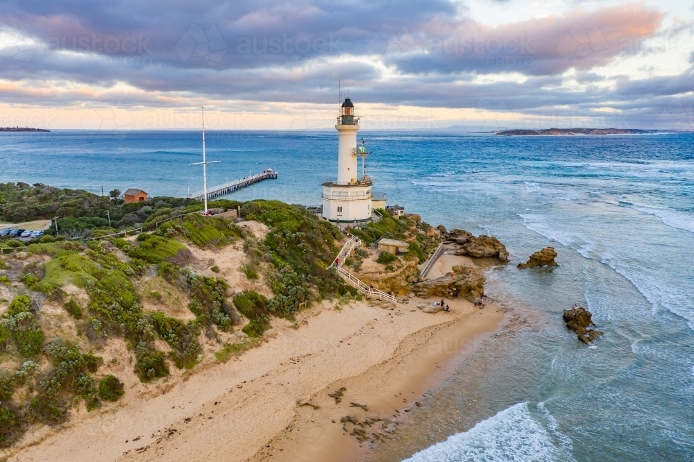 Image of Aerial view of a lighthouse sitting on a rocky point at the ...