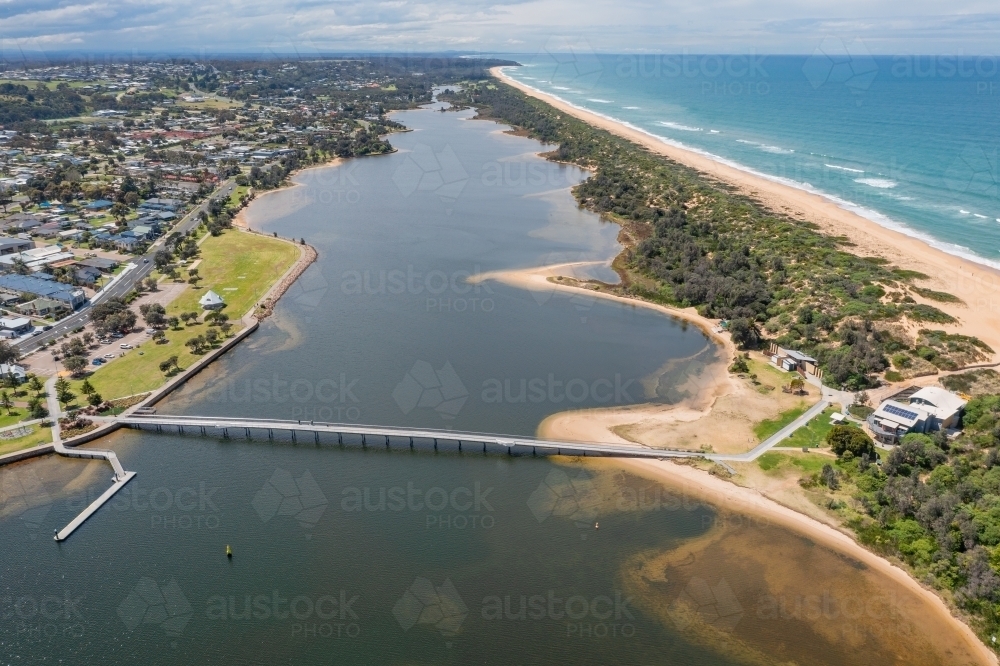 Image of Aerial view of a long foot bridge over a lagoon linking a ...