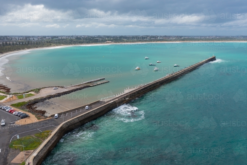 Image of Aerial view of a long narrow breakwater jutting out into a ...