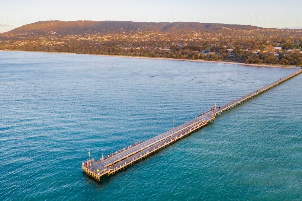 Image of Aerial view of a long narrow jetty coming off a beach at ...