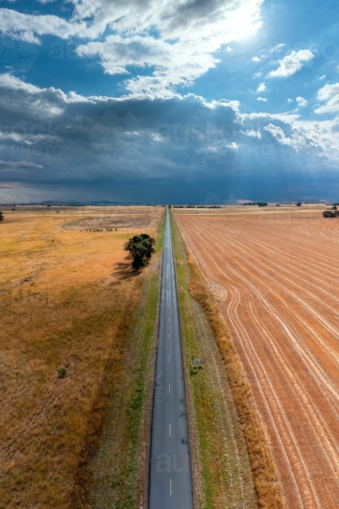 Image of Aerial view of a long straight country road between dry ...