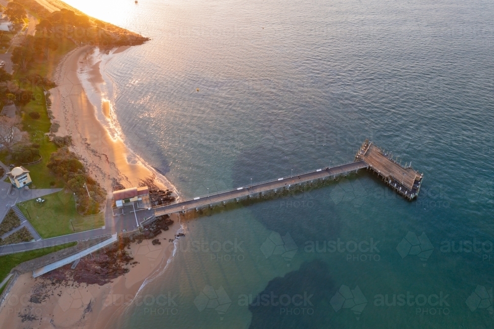 Image of Aerial view of a long straight jetty leading out to a platform ...