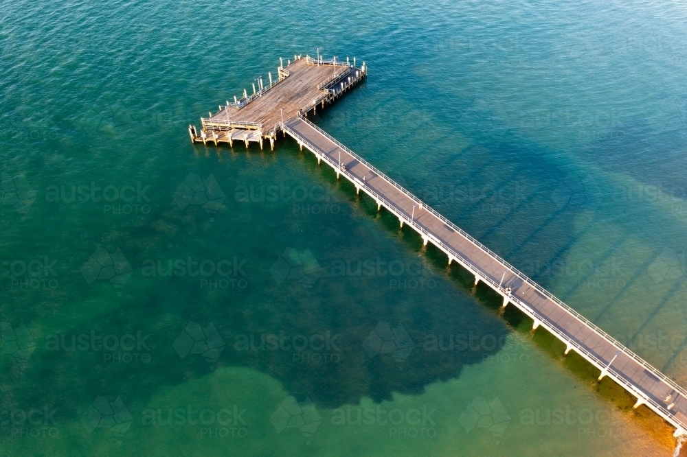 Image of Aerial view of a long straight jetty leading out to a platform ...