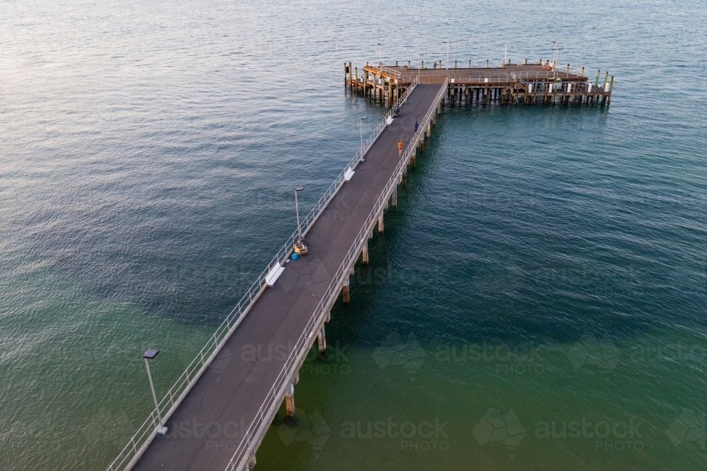 Image of Aerial view of a long straight jetty leading out to a platform ...