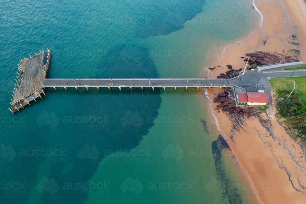 Image of Aerial view of a long straight jetty leading out to a platform ...