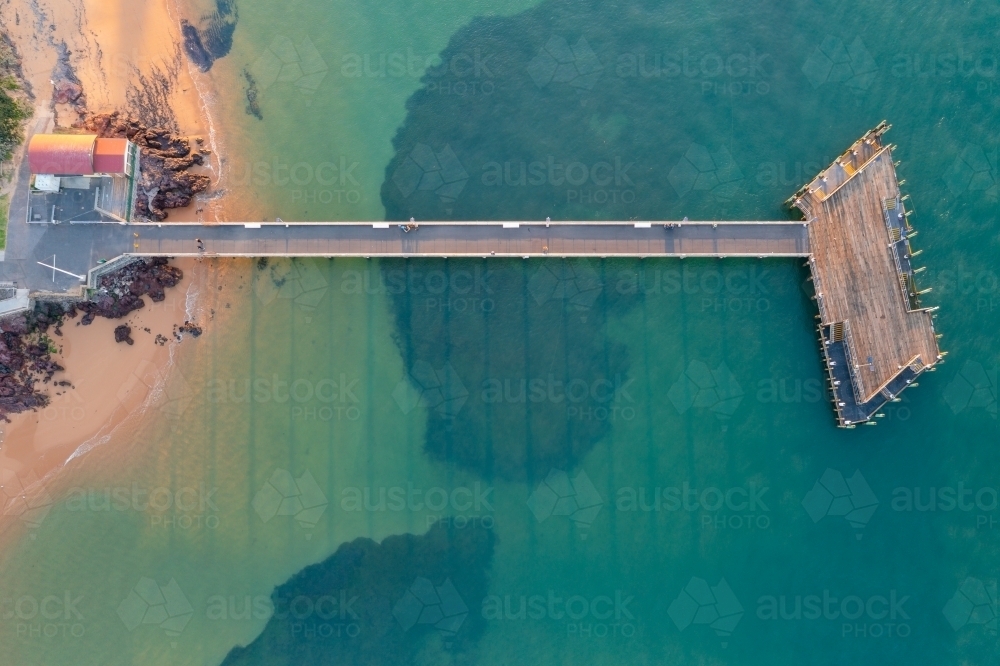 Image of Aerial view of a long straight jetty leading out to a platform ...