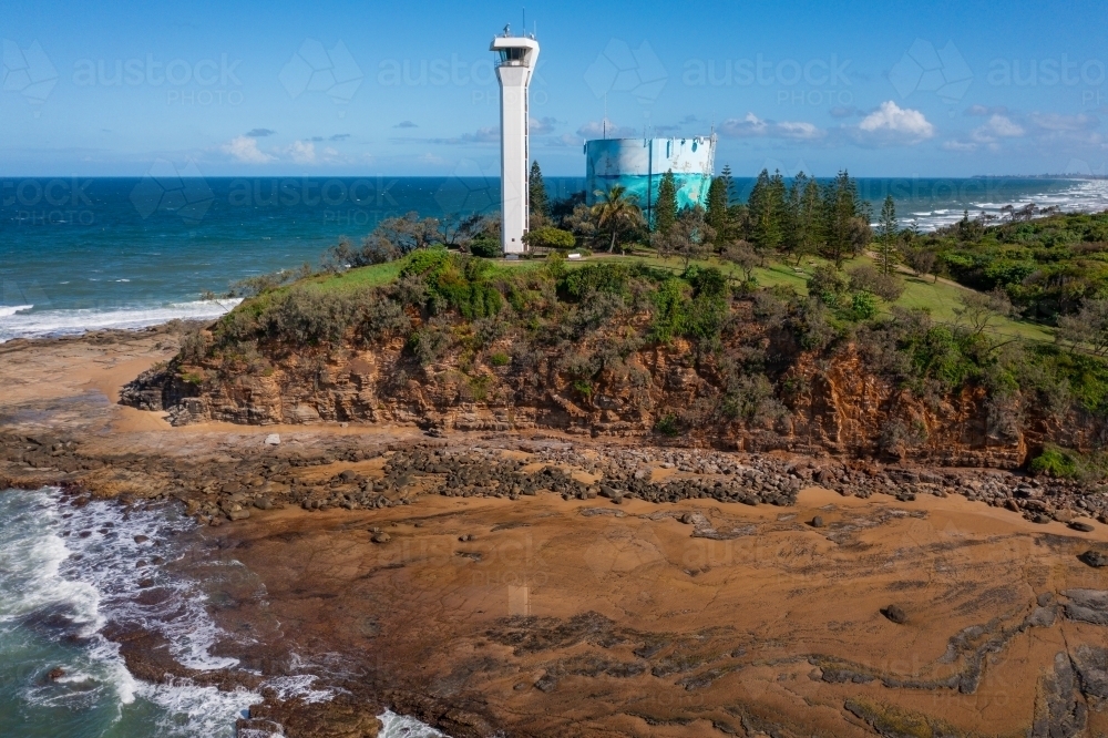 Image of Aerial view of a modern lighthouse on a clifftop next to a ...