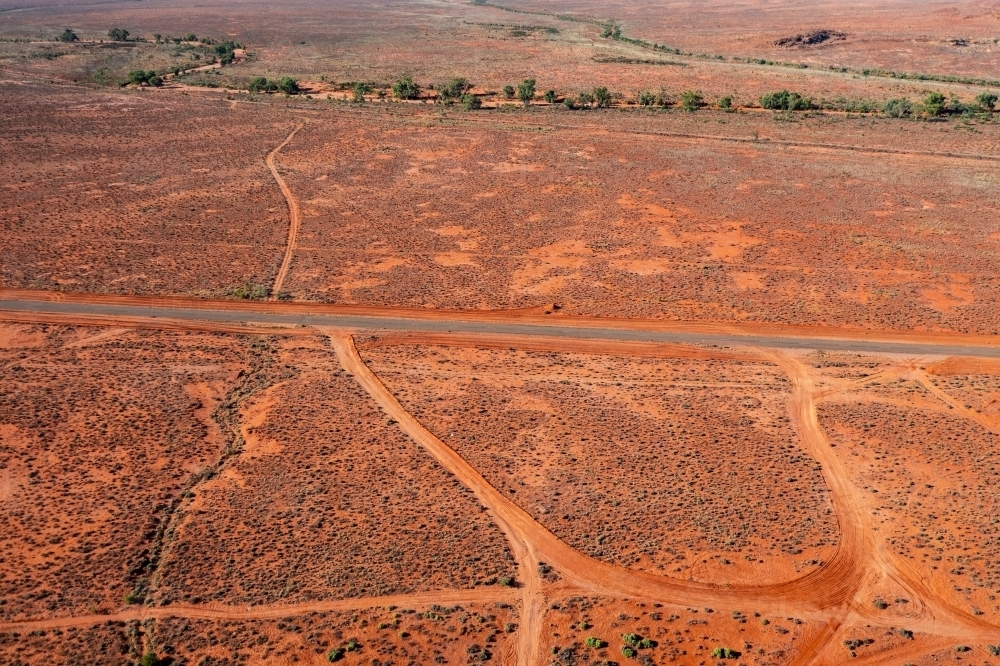 Image of Aerial view of a narrow bitumen road and dirt tracks running ...